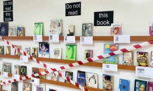 TK library's DO NOT READ THIS BOOK sign | CIS Mosaic